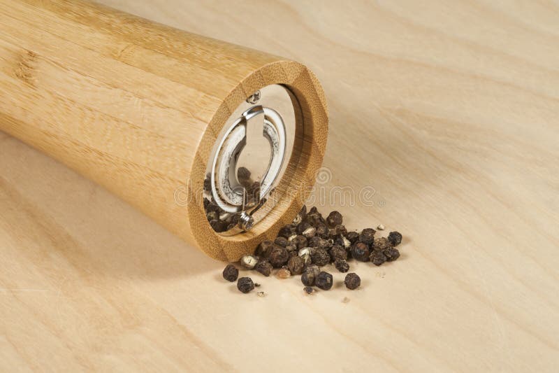 Bamboo Pepper Grinder with Grains on the Table Stock Image - Image of ...