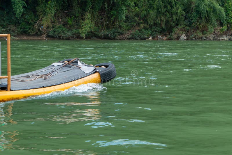 A Bamboo Raft Paddling on the River Stock Photo - Image of water ...