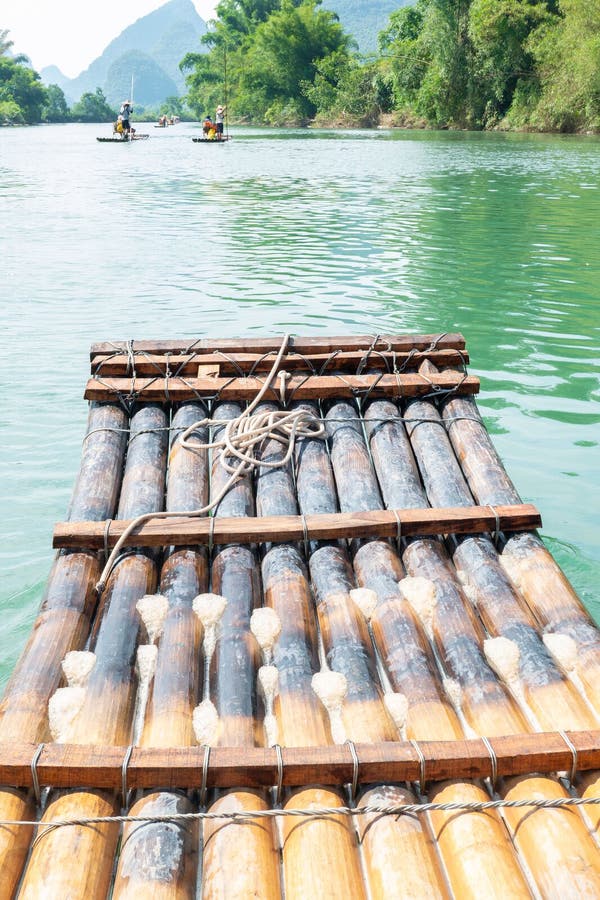 A Bamboo Raft Paddling on the River at Vertical Composition Stock Image ...