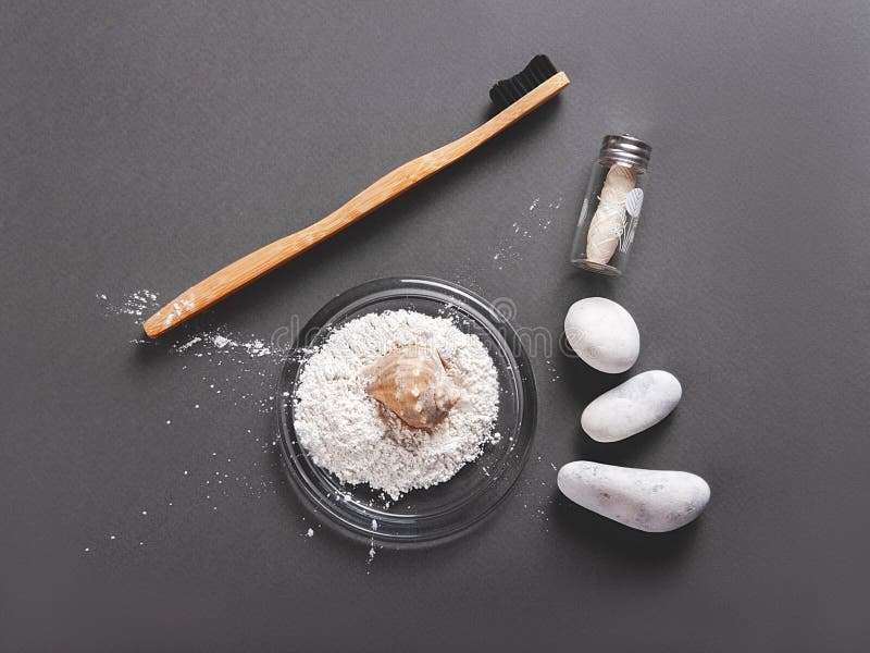 A Bamboo Toothbrush with a Floss in a Glass and Toothpowder Decorating ...