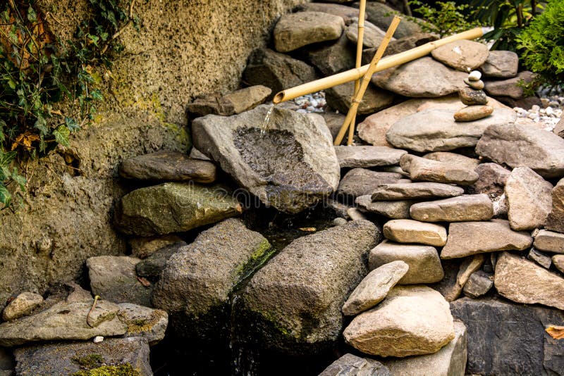 Bamboo Water Feature and Stones in the Garden Stock Photo - Image of ...