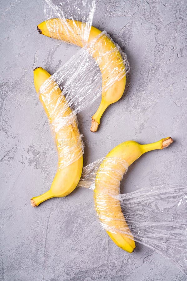 Banana Fruit Wrapped in Stretch Wrap Plastic on Stone Concrete ...