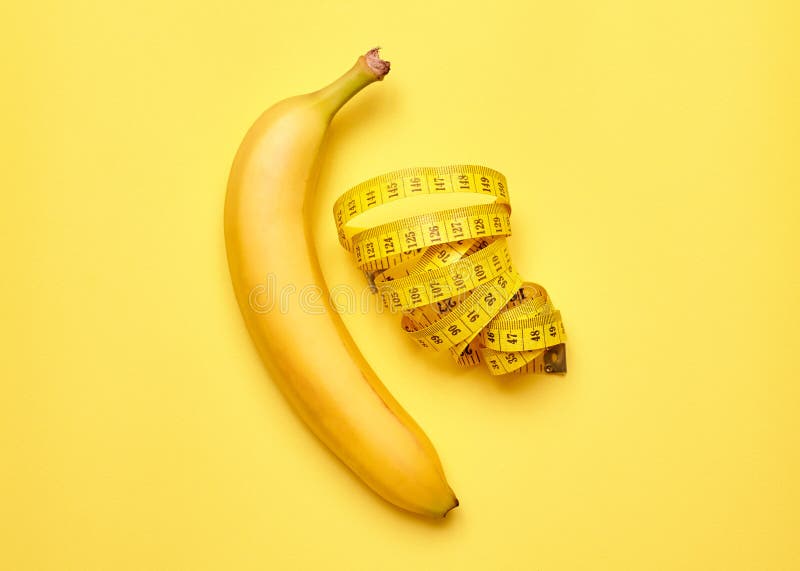 Banana with Measuring Tape on a Yellow Background Stock Image - Image ...