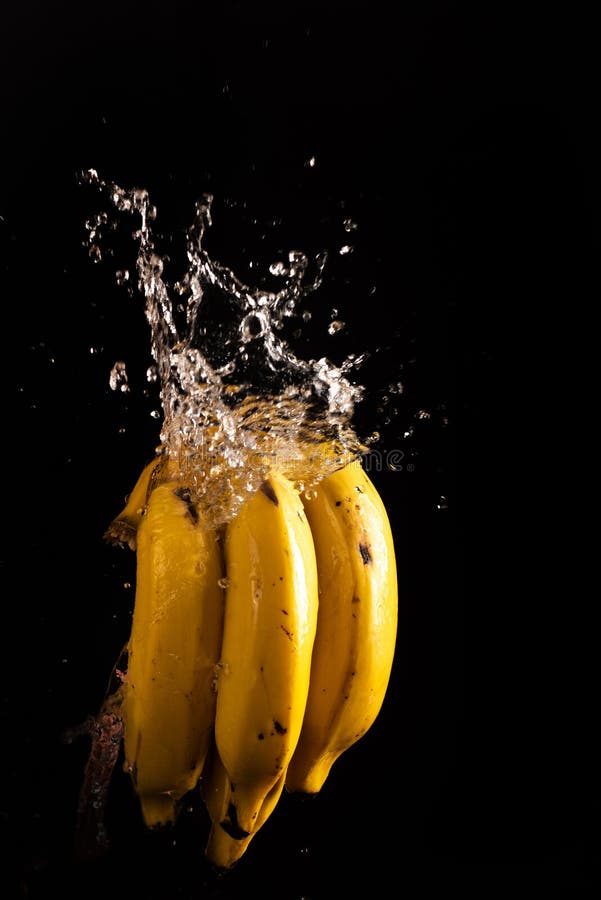 Bananas Splash in Water To Movement Over Black Background Stock Photo ...