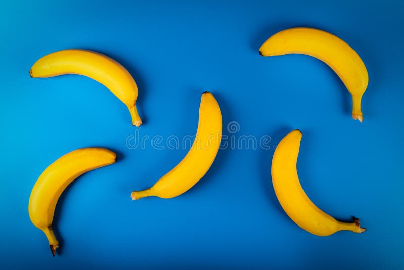 Bananas on blue background stock photo. Image of background - 124336474