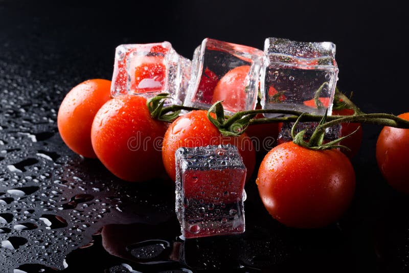 Banch of Red Cherry Tomatos and Ice Cubes on Black Wet Table. Se Stock ...