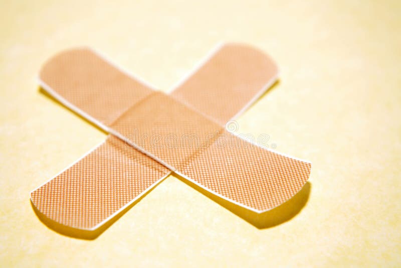 Two Band-aids in Cross Shape Stock Photo - Image of background, indoors ...