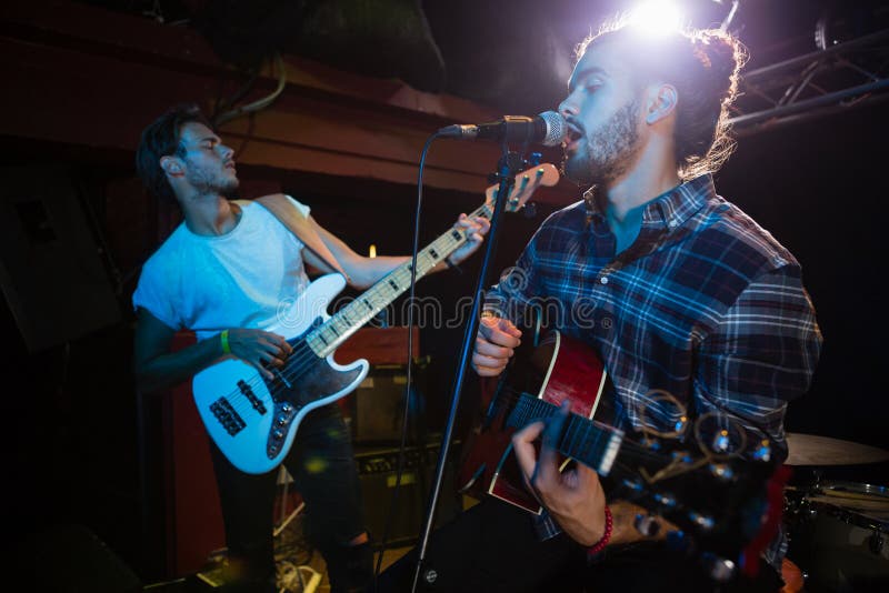 Band performing on stage stock photo. Image of handsome - 93235596
