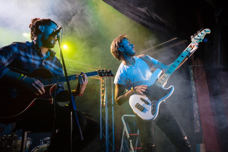 Band performing on stage stock image. Image of microphone - 93235699