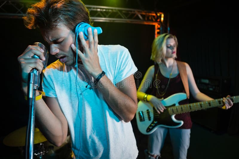 Band performing on stage stock image. Image of female - 93235761