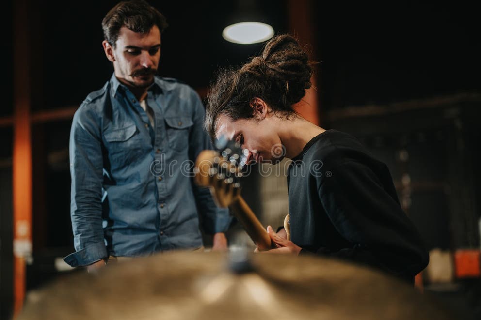 Two Musicians Preparing Instruments during Band Practice in a Studio ...