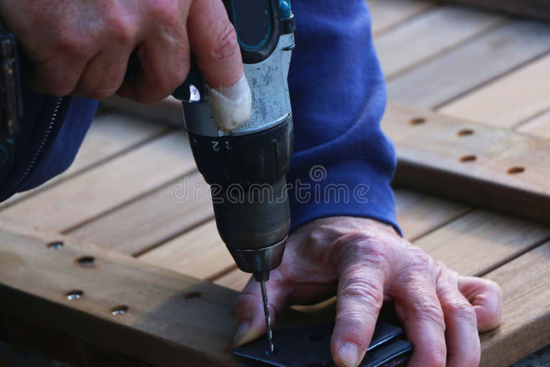 Close Up of the Hand of a Senior Man Who is Using a Drill Bit To ...