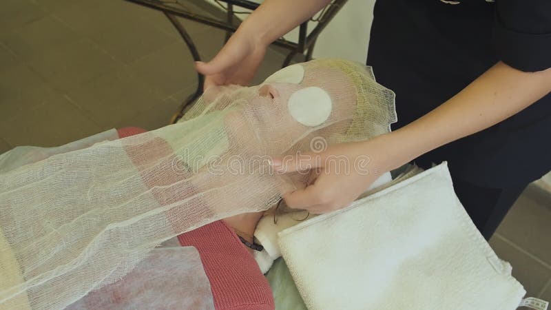 A Bandage Mask Using Gauze Fabric. Apply Gauze on Face with Cream ...