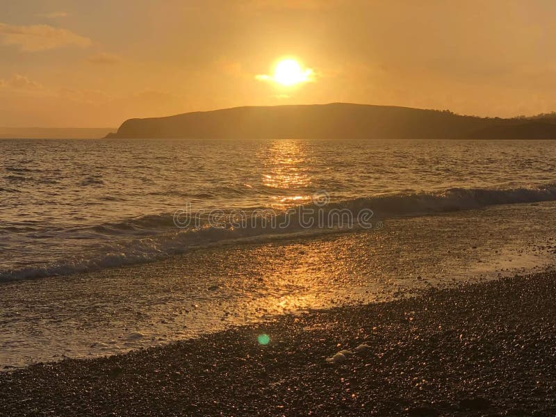 The Sun Setting Behind the Mountains To the Sea Stock Photo - Image of ...