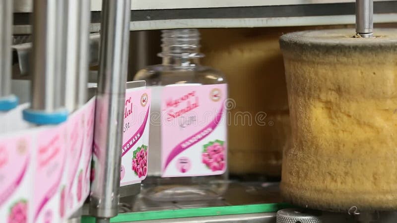 A Closeup of Plastic Bottles Being Labelled by a Labelling Machine ...