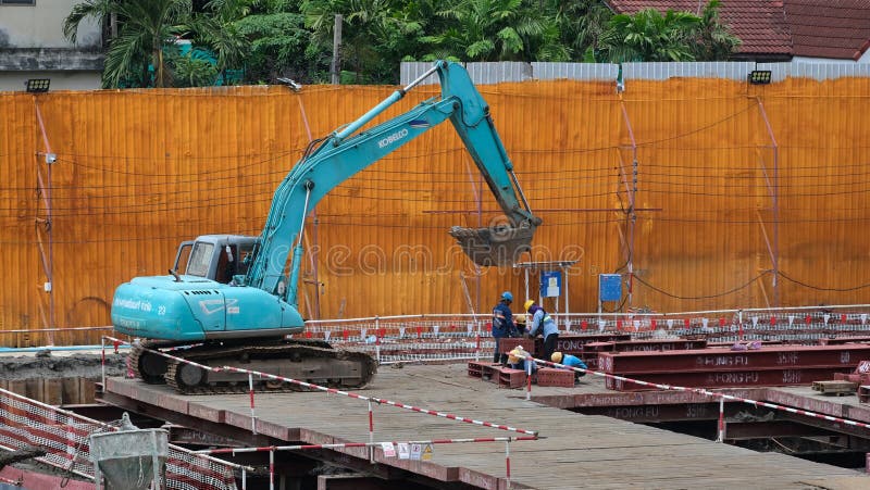 Excavator and Workers on a Construction Site Editorial Photography ...