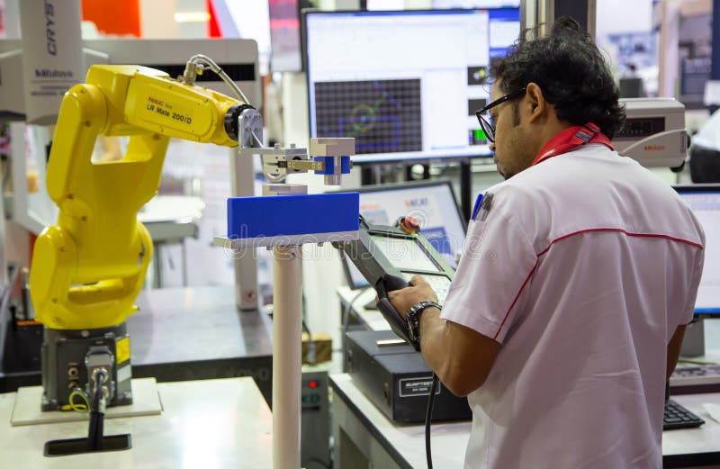 Worker Control Robot Arm To Loading And Unloading Workpiece Editorial Photo Image Of Operate