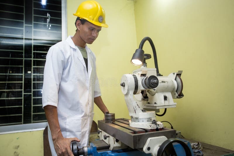 Bangladesh â€“ May 20, 2015: a Factory Lab Operator Using Steel Rod ...