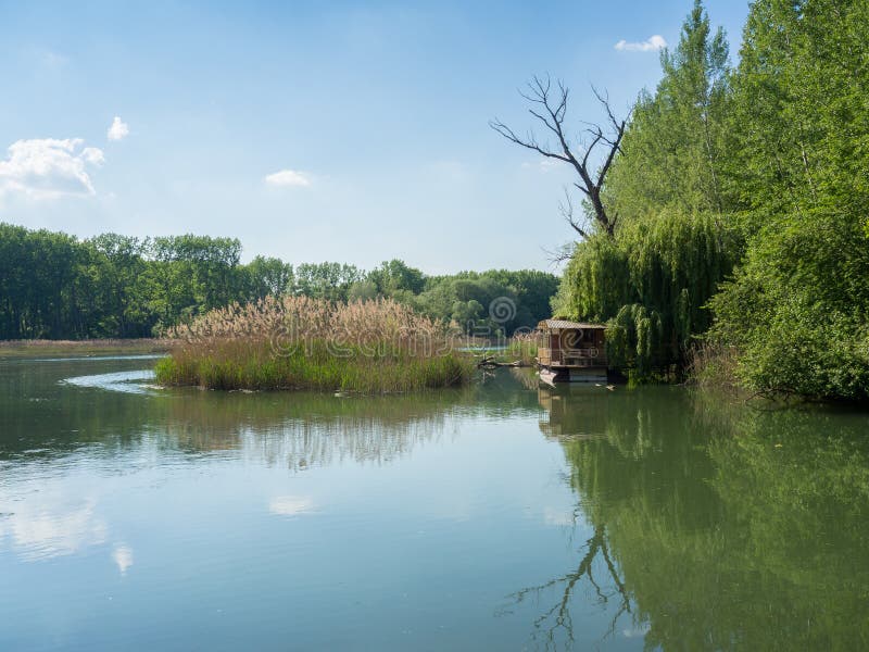 Bank of the Danube River with Houseboat and Reflections Stock Photo ...