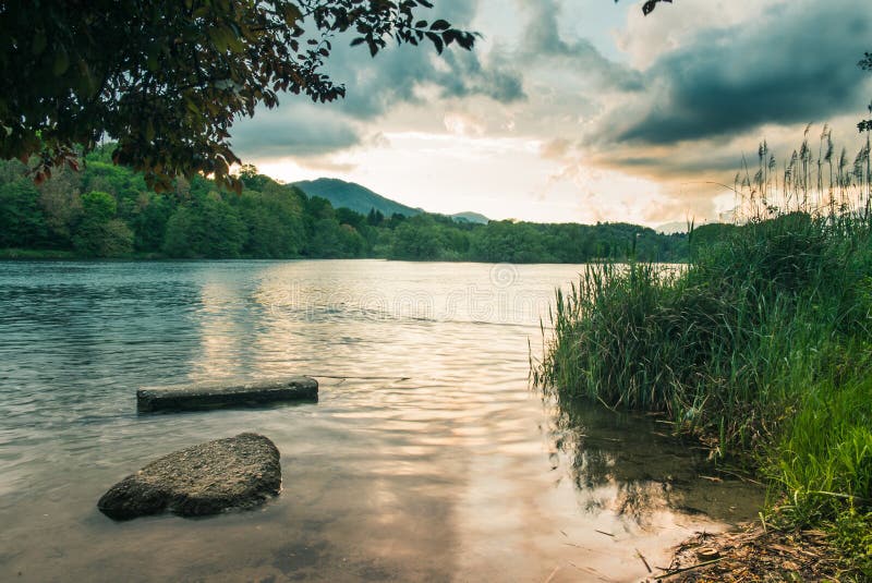 On the Bank of a River at Sunrise Stock Image - Image of faced, grey ...