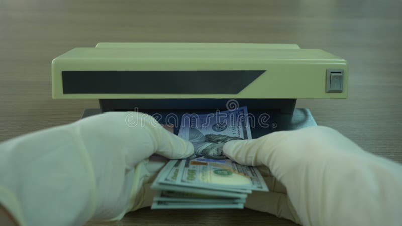 Banker Hands in Gloves Checking for Counterfeit Money Detecting Under ...