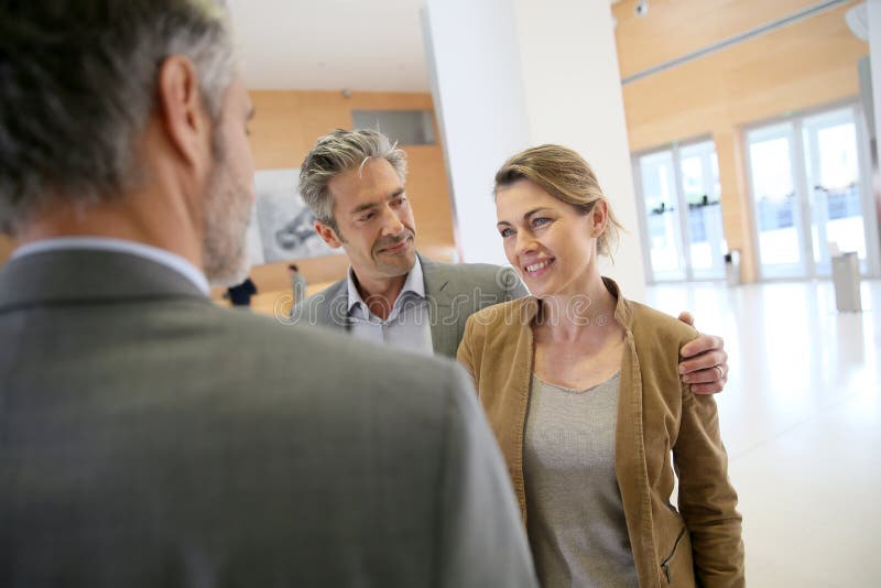 Banking Advisor and Clients Handshaking Stock Image - Image of clients ...