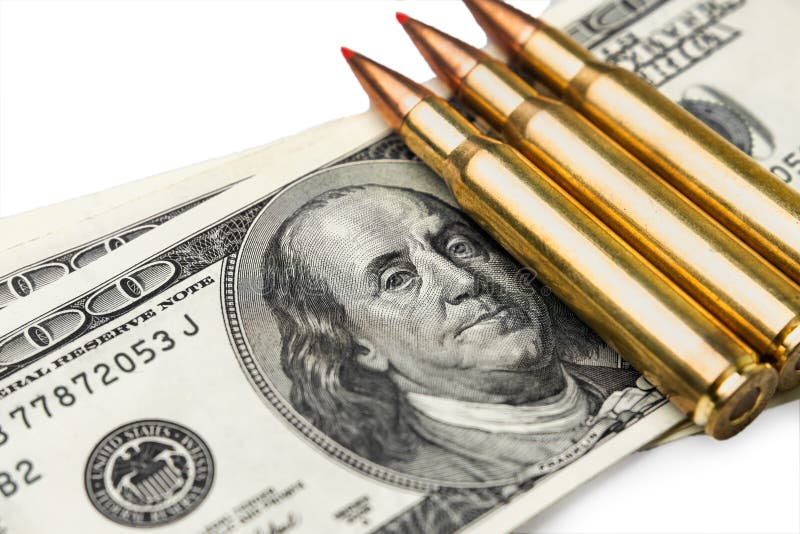 On the Banknotes of Dollars are Fighting Bullets Close-up. Concept of ...
