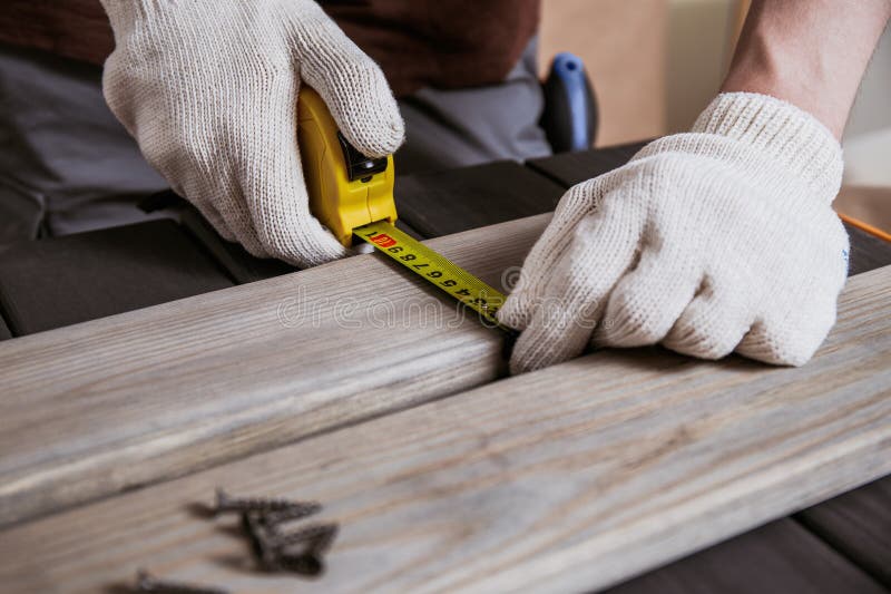 Banner of Carpenter Measuring a Wooden Plank by Ruler in Wooden ...