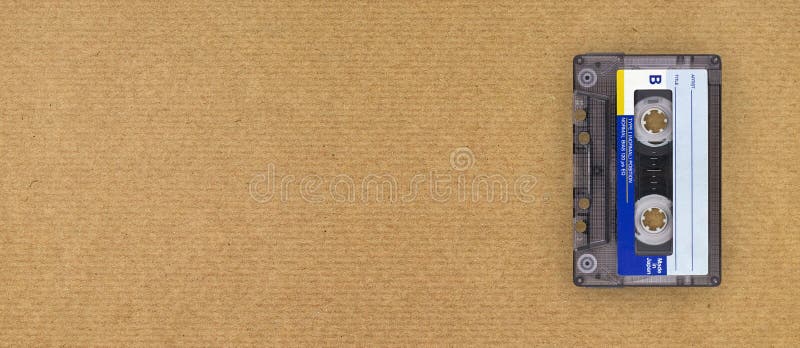 Retro Cassette Tape on a Beige Textured Paper Surface Stock Image ...