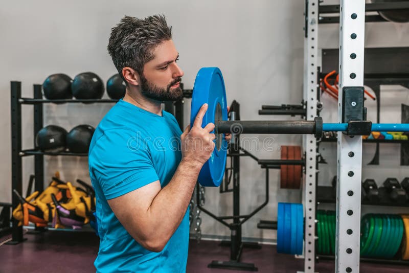 Athlete Putting Weights on a Bar-bell Stock Image - Image of weight ...