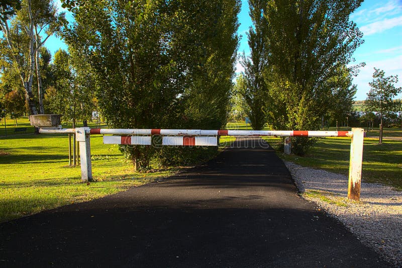 A Bar that Blocks a Road of a Park at Sunset Stock Photo - Image of ...