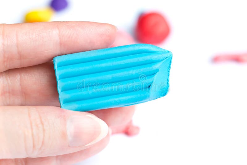 A Bar of Blue Plasticine in the Hand of a Woman. Stock Image - Image of ...