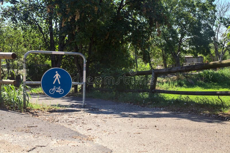 Bar with a Blue Sign at the Beginning of a Path Bordered by Trees in ...