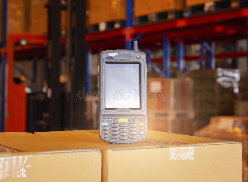 Bar Code Scanner on Package Box at Storage Warehouse. Computer Tools ...