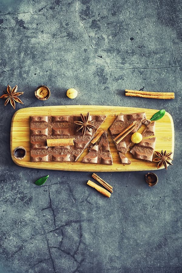 A Bar of Milk Chocolate on the Table. Chocolate with Nuts and Cinnamon ...