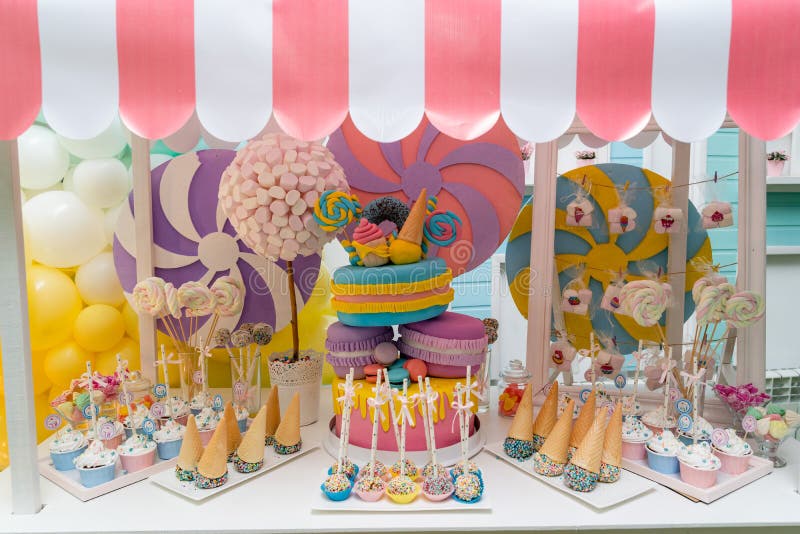 Bar with Sweets and a Three-story Multi-colored Cake with Macarones ...