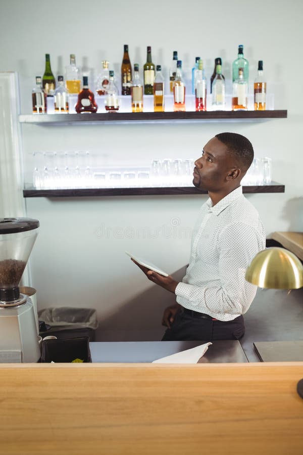 Bar Tender Writing on a Clipboard at Bar Counter Stock Image - Image of ...