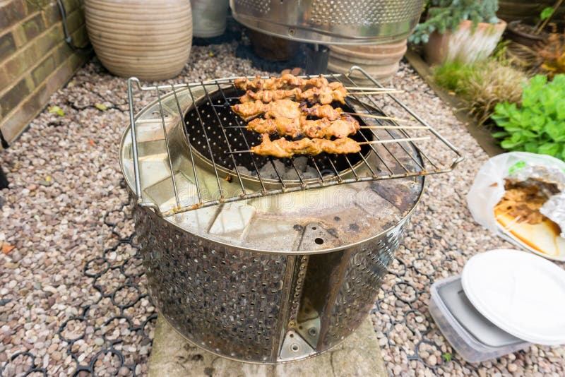 Barbecue in a back garden stock photo. Image of summertime - 87780374