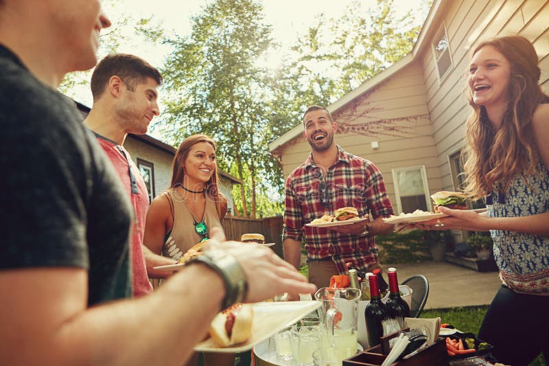 Barbecue Bash. a Group of Friends Having Lunch in Their Backyard. Stock ...