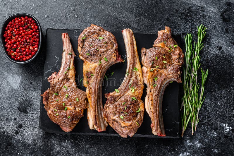 Barbecue Fried Lamb Meat Chops on a Marble Board. Black Background ...