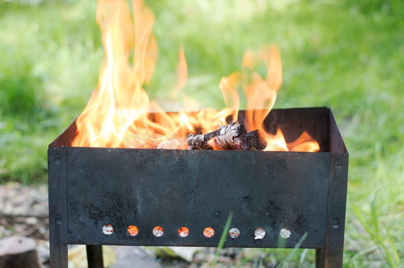 Barbecue Grill with Fire on Nature Background. Stock Photo - Image of ...