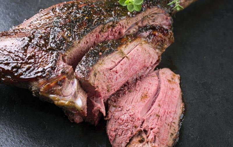 Barbecue Haunch of Venison with Marinade on a Black Board Stock Photo ...