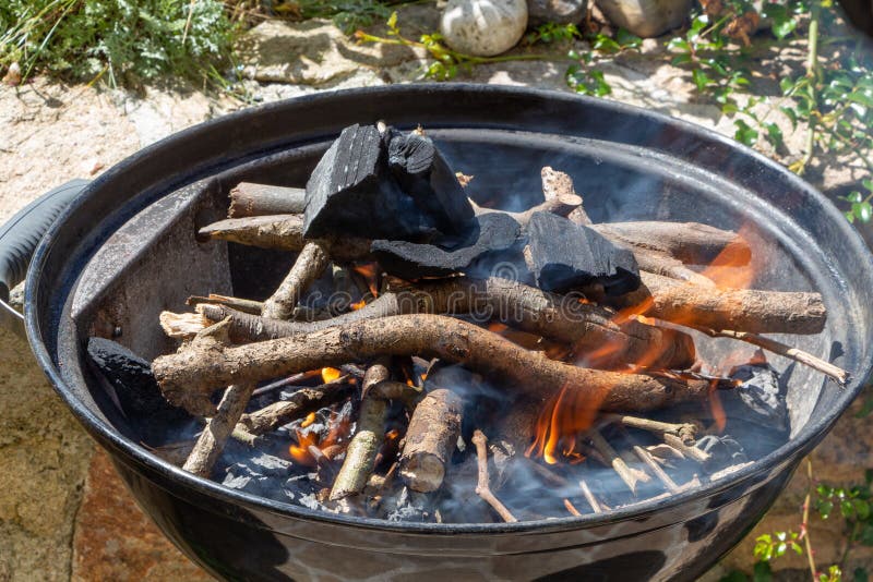 Barbecue lit in a garden stock image. Image of flame - 208054175