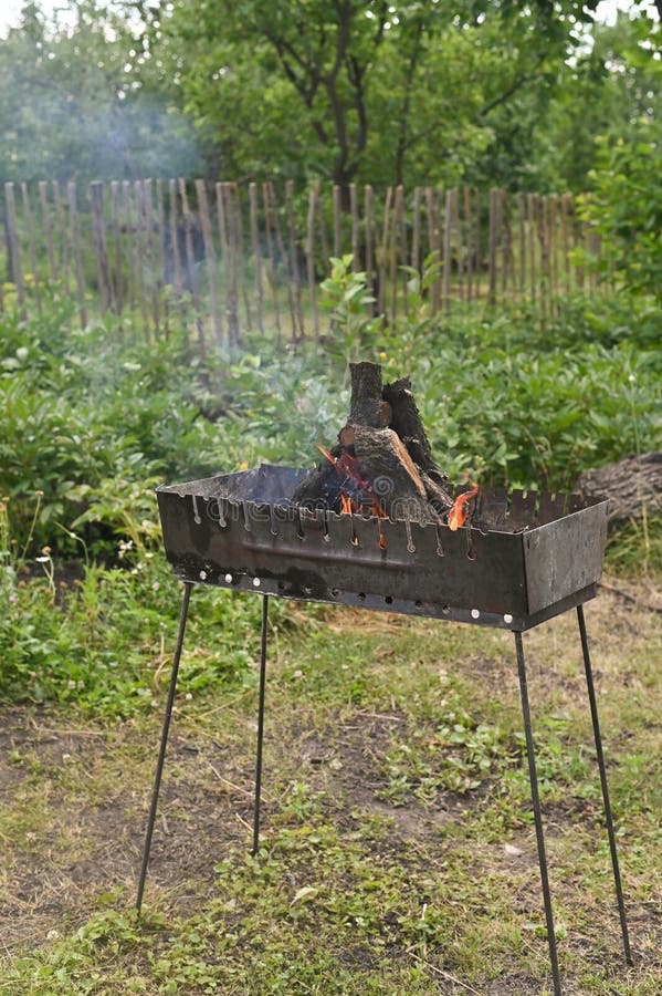 A Barbecue in Which Firewood is Burning. Stock Image - Image of smoke ...