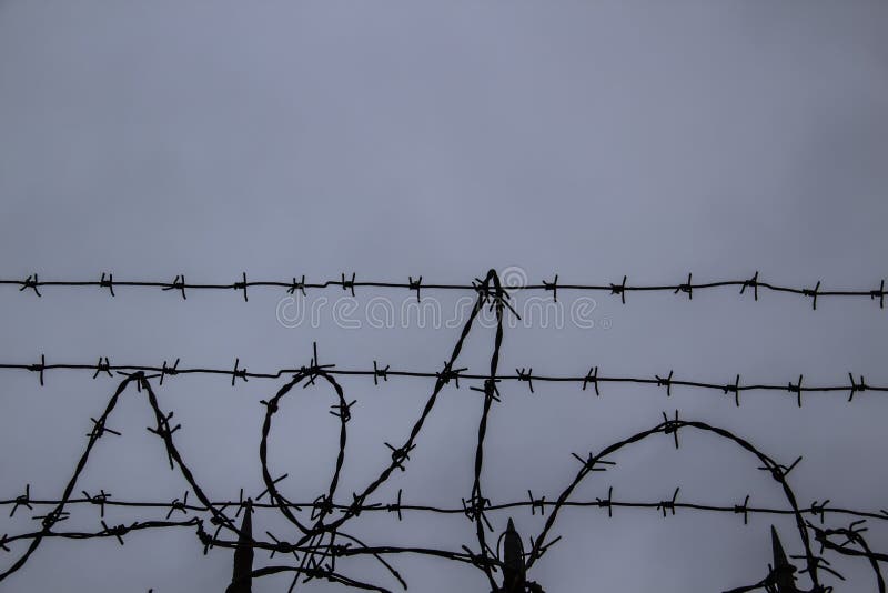 Barbed Wire Fence on Against Grey Sky Background Stock Image - Image of ...