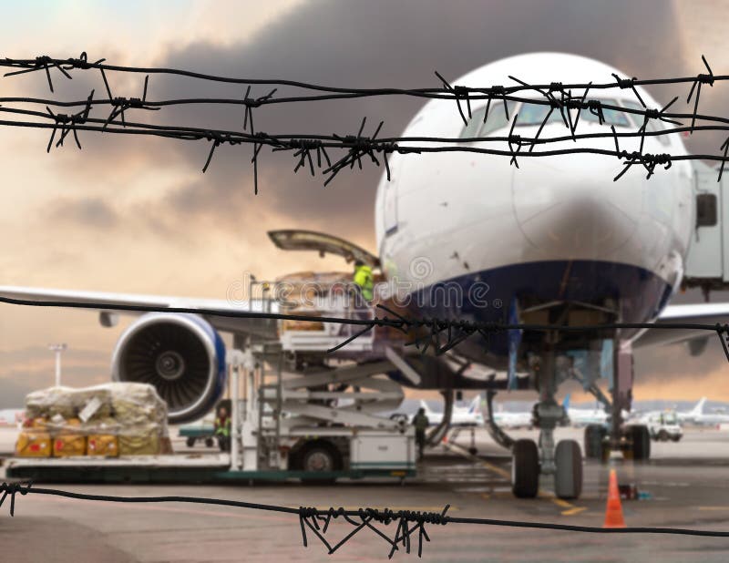 Barbed Wire Fence in Front of Loading Cargo on Plane in Airport Stock ...