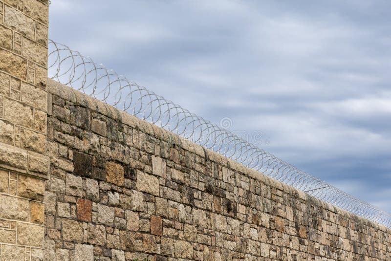 Barbed Wire Fence on High Wall Perimeter for Security and Protection ...