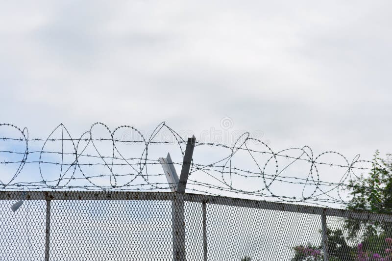 Security Fence with Barbed Wire Stock Photo - Image of penitentiary ...