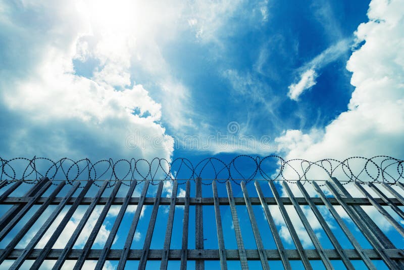 Barbed Wire Fence Surrounding a Prison , Military or Other High ...