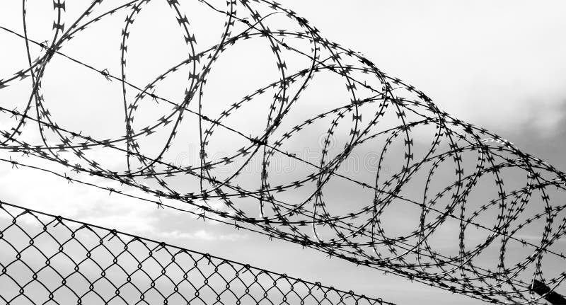 Barbed Wire Over a Metal Fence - Security or Reclusion Concept Stock ...